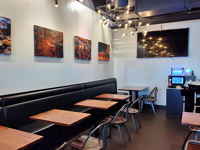 Modern minimalism meets Malaysian warmth in this dining room where colorful food art serves as a preview of coming attractions for your plate.