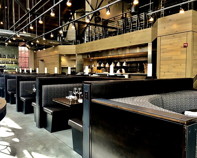 These booths aren't just seating&mdash;they're intimate dining islands in a sea of industrial chic. Edison bulbs overhead cast everyone in their best light.