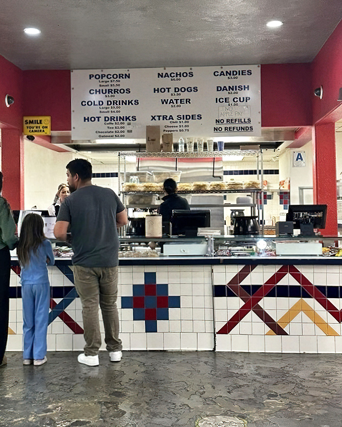 The concession stand—where movie theater classics meet unexpected delights. Those colorful tiles have witnessed decades of snack decisions.