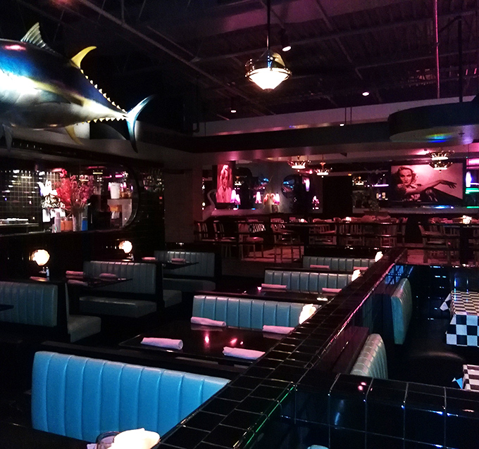 Blue banquettes and mood lighting create the perfect backdrop for conversations that flow as smoothly as the wine. Note the marlin keeping watch.