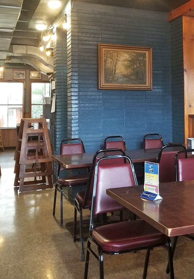 The blue accent wall and burgundy chairs create that classic "Florida fish house" vibe where comfort trumps pretension every time.