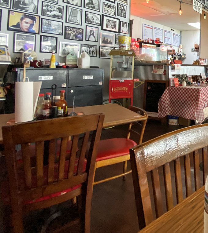 Vintage frames and wooden tables create that "been here forever" vibe. Even the popcorn machine in the corner seems to tell stories.