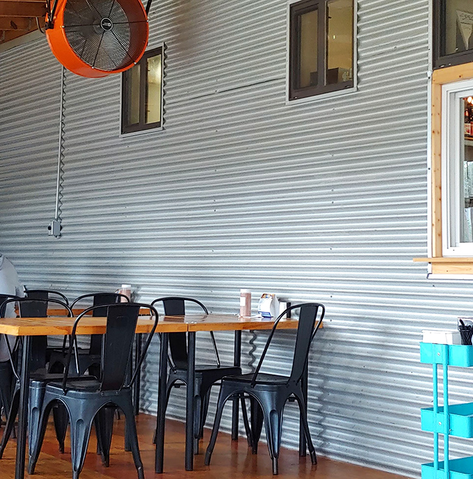 Corrugated metal walls and industrial fans create that perfect mix of warehouse-chic meets neighborhood barbecue joint everyone secretly wants nearby.