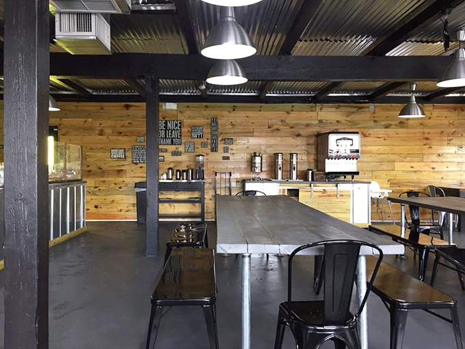 Industrial-chic meets Southern comfort in Se7enBites' dining area, where wooden walls and metal accents create the perfect backdrop for biscuit-induced happiness.