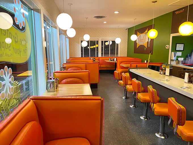 The interior's mid-century modern design with signature orange booths creates the perfect backdrop for your inevitable food photography session.