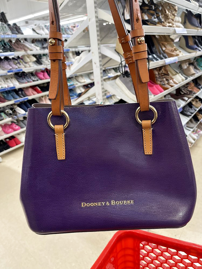 A purple Dooney & Bourke handbag posing proudly against a backdrop of footwear &ndash; luxury meets affordability in this serendipitous find.