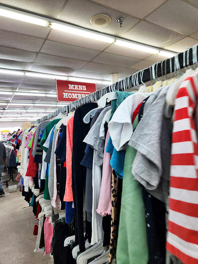 The Men's section stands ready for exploration, where Hawaiian shirts and corporate polos coexist in peaceful harmony unlike their original owners ever could.