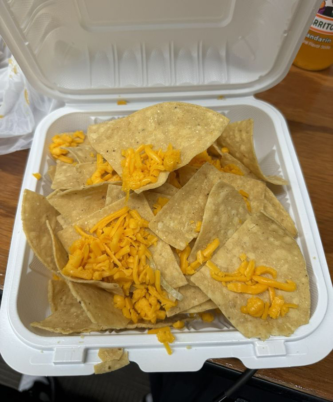 These nachos aren't trying to impress with architectural height—they're honest chips with generous cheese that understand sometimes simple pleasures are the most satisfying.