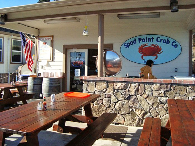The stone foundation and wooden picnic tables create the perfect rustic backdrop for seafood feasting. No white tablecloths needed when the food speaks this eloquently.