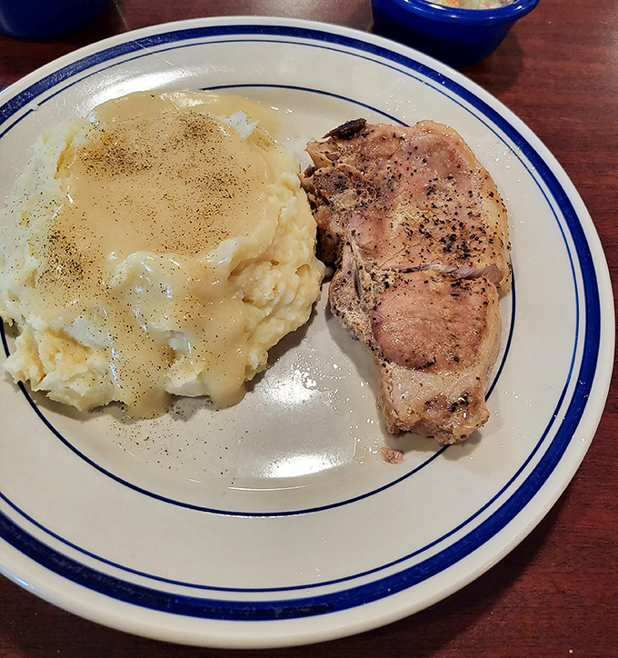 A perfectly seared pork chop keeping company with buttery mashed potatoes. Simple food done right is the highest form of culinary art.