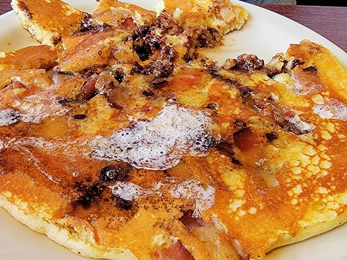 This isn't just a pancake &ndash; it's a canvas of golden-brown perfection dotted with berries and bacon. Breakfast as art form.