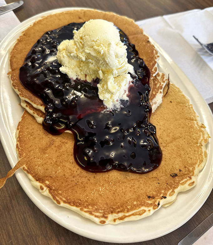 Pancakes crowned with blueberry compote and ice cream. Breakfast? Dessert? The line blurs deliciously when comfort food reaches this level.