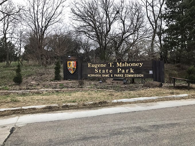 The entrance sign stands like a promise of adventure, welcoming visitors to a place where Nebraska's natural beauty takes center stage.