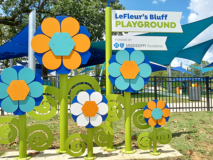 The whimsical entrance to LeFleur's Bluff Playground blooms with oversized flowers that make adults feel like they've shrunk or children feel like explorers in a giant's garden.