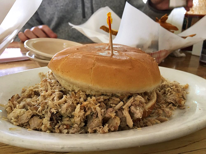 The open-faced pork sandwich doesn't hide behind pretense&mdash;just a humble bun absolutely overwhelmed by a glorious heap of smoky meat.