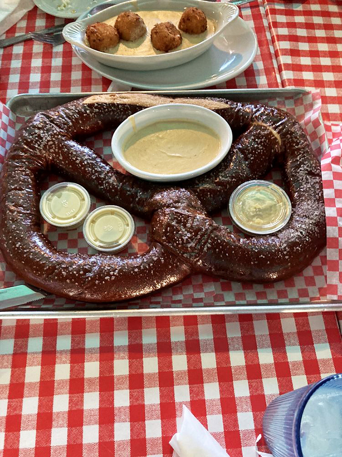 This isn't just any pretzel&mdash;it's a carb masterpiece that requires its own zip code. The accompanying dipping sauces are merely supporting actors in this bread drama.