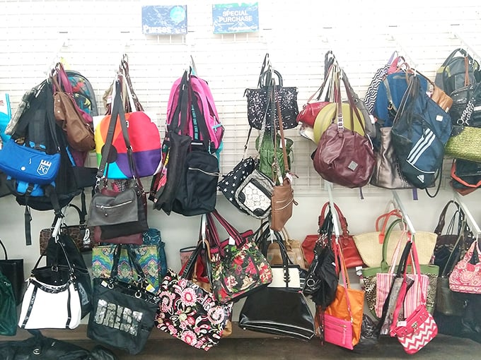 The handbag wall&mdash;a kaleidoscope of colors and textures. Each one previously carried someone's essentials and secrets.