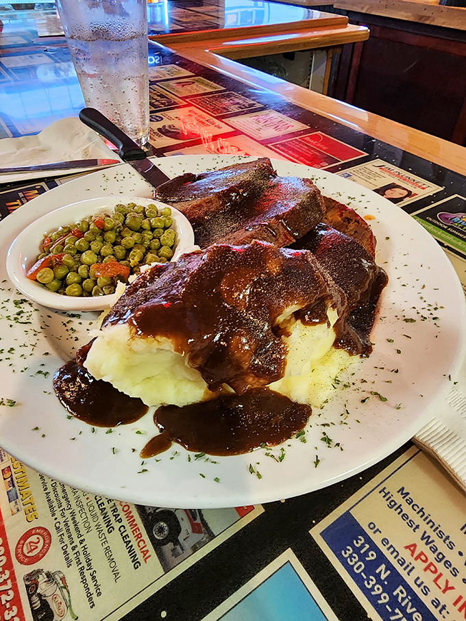 Comfort food royalty: tender roast beef lounging on a throne of mashed potatoes, draped in rich gravy. The peas add color, but we know why you're really here.