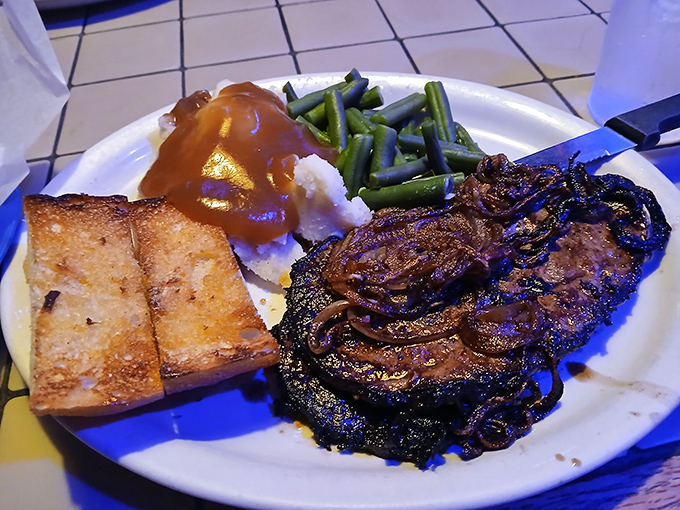 This isn't just dinner&mdash;it's a commitment. A steak that's been properly caramelized, green beans that haven't been forgotten, and garlic bread ready to soak up every last drop of gravy.