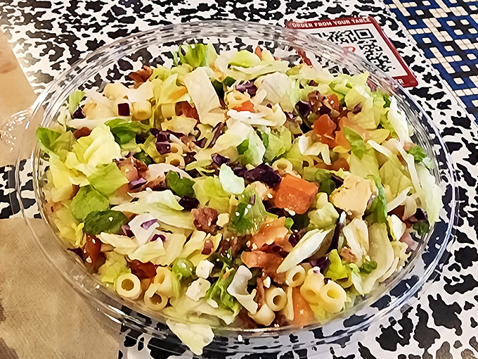 Even the salad looks like it's ready for a party, with pasta, veggies, and enough color to make your average bowl of greens feel underdressed.
