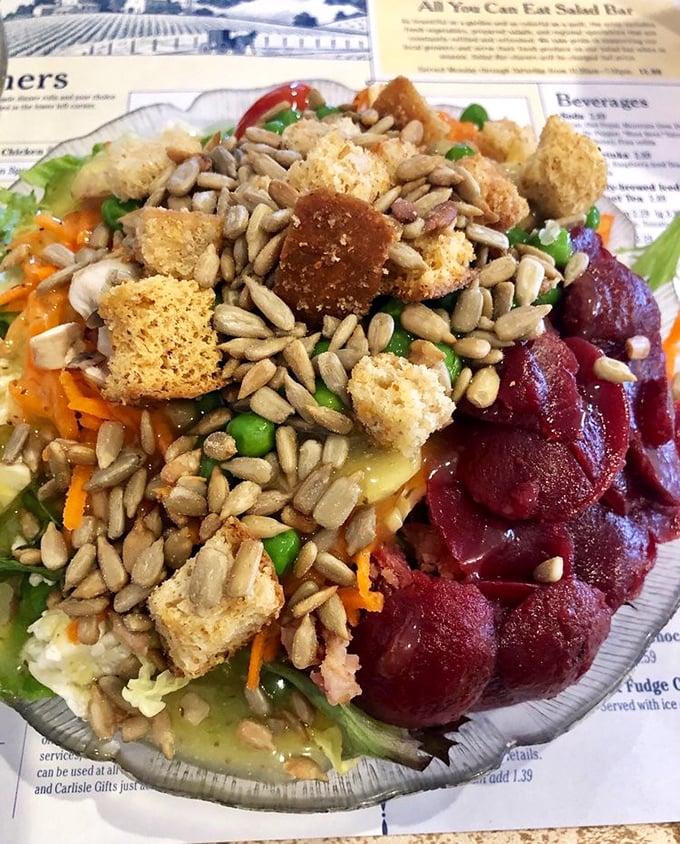 A salad that defies the "rabbit food" stereotype &ndash; loaded with sunflower seeds, croutons, and what appears to be pickled beets, bringing color and crunch to every bite.