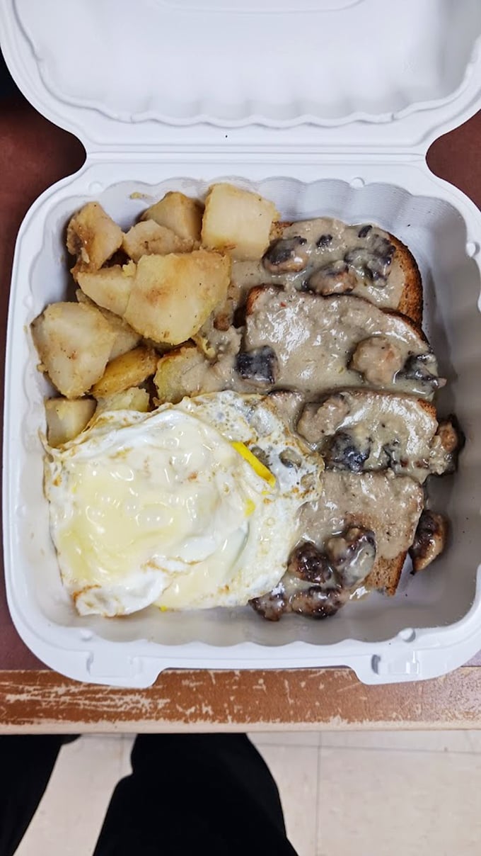 Sausage gravy cascading over toast with a perfectly fried egg alongside&mdash;comfort food that makes you want to hug whoever invented breakfast.