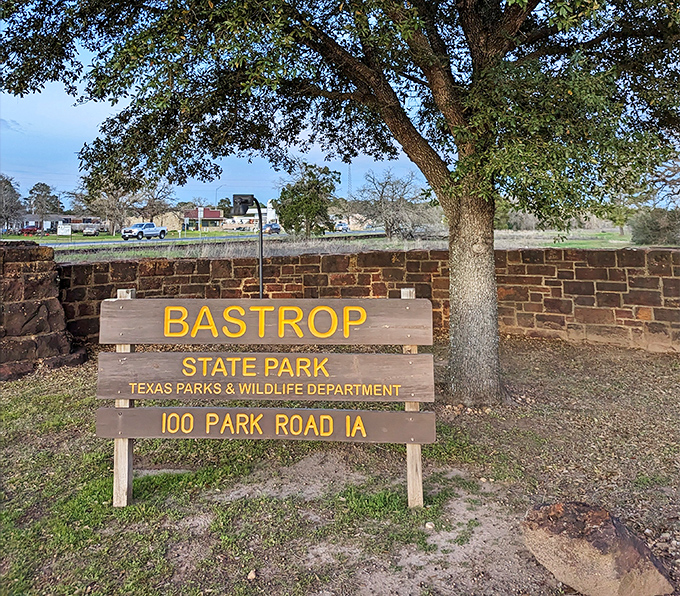 The entrance sign promises adventure while the stone wall whispers history. Your GPS might say "arrived," but your journey's just beginning.