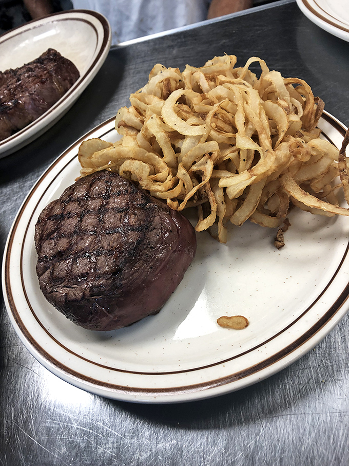 A perfectly cooked filet mignon alongside a mountain of crispy onion straws&mdash;a classic pairing that never goes out of style for very good reason.