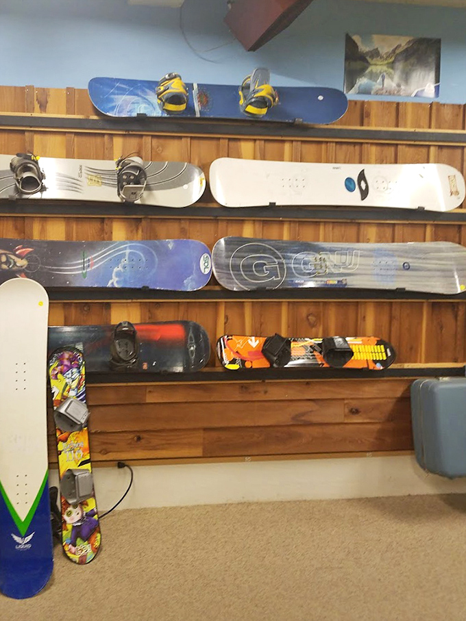 Snowboards and skis patiently waiting for their next powder day. Winter sports equipment with character that doesn't require a second mortgage.