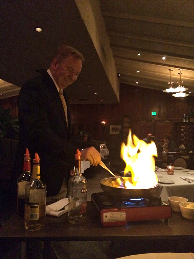 Tableside flambé isn't just cooking—it's dinner theater at its finest. The flames dance higher than your eyebrows, which is precisely the point.