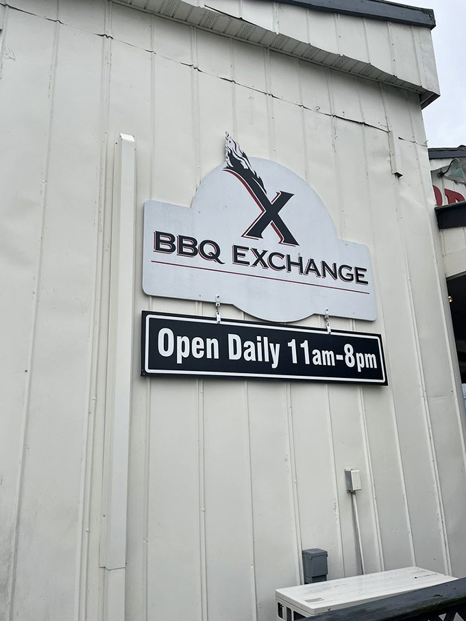 The sign promises BBQ Exchange is "Open Daily 11am-8pm," but the smart money arrives early before the brisket sells out.