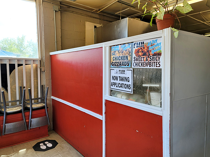 The ordering window&mdash;where dreams and hunger meet reality. Those signs promise chicken gizzards that might just change your mind about offal.