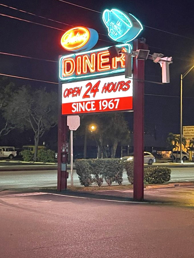 The neon glow at night transforms this diner into a lighthouse for the hungry, beckoning travelers 24 hours a day.