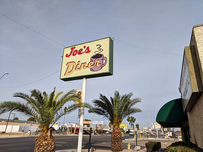 The Joe's Diner sign stands sentinel between palm trees, a beacon of breakfast hope in the Arizona sun.