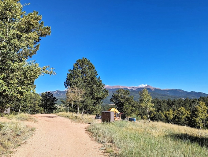 The trail beckons with promises of panoramic views. That mountain backdrop is Colorado's version of a celebrity photobomb.