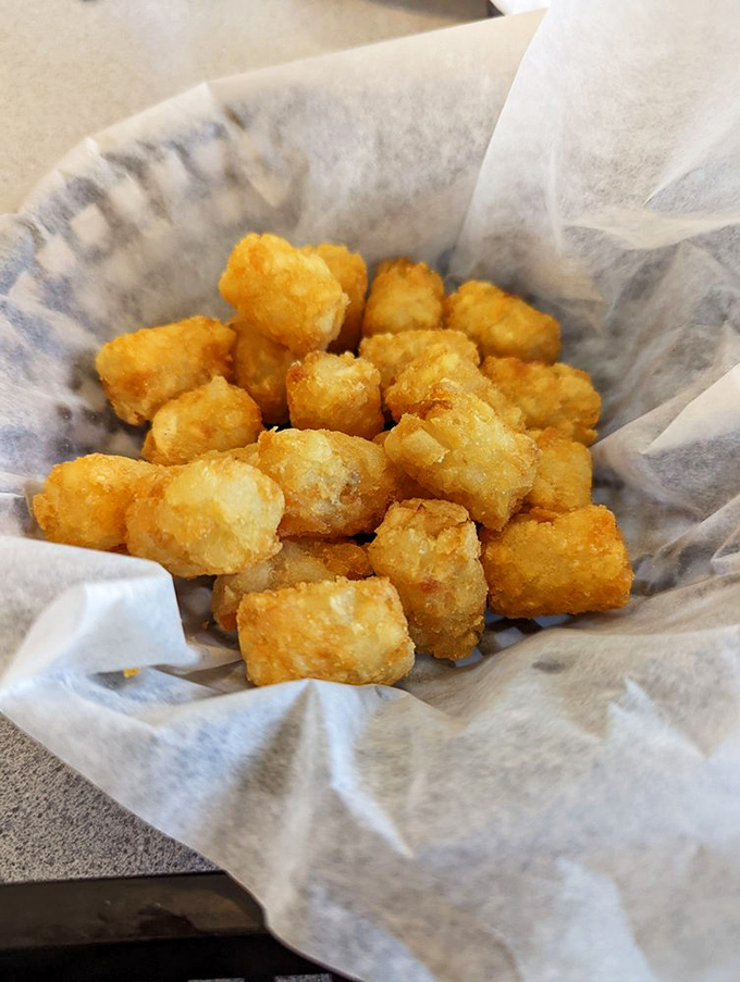 Golden tater tots nestled in paper&mdash;each one a perfect little time machine back to the best school lunch you ever had.