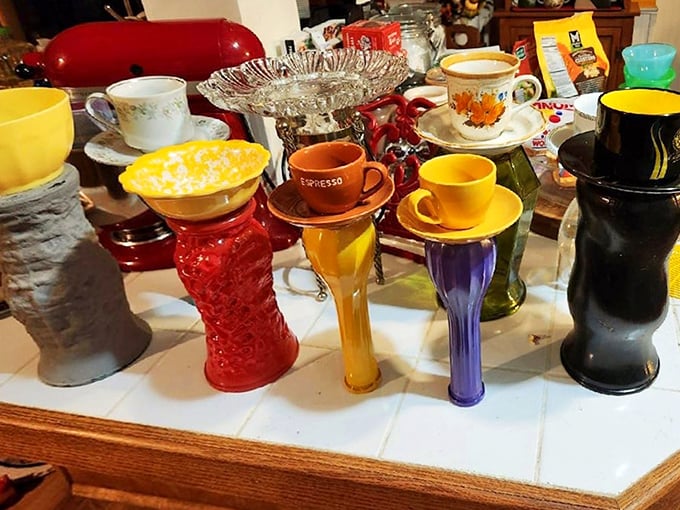 A colorful congregation of cups and saucers having what appears to be the world's most sophisticated tea party. Mismatched perfection at its finest.