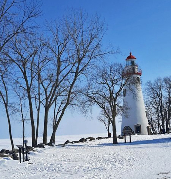 Winter transforms Marblehead into a snow globe come to life, with the lighthouse standing defiant against Lake Erie's frozen beauty.