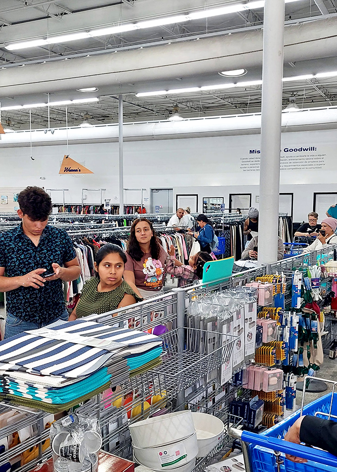 The unspoken choreography of bin-diving. Seasoned shoppers develop a sixth sense for spotting quality amid the colorful textile landscape.