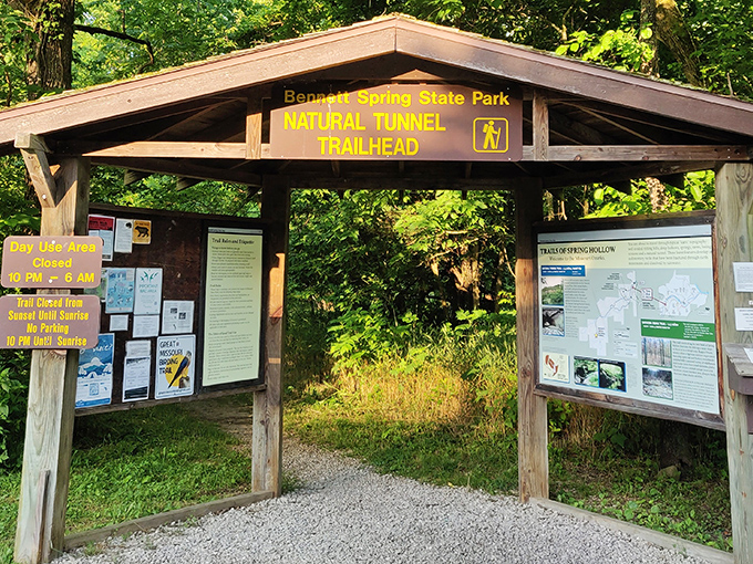 Adventure begins at this unassuming gateway, where a wooden sign promises natural wonders just beyond the trailhead.