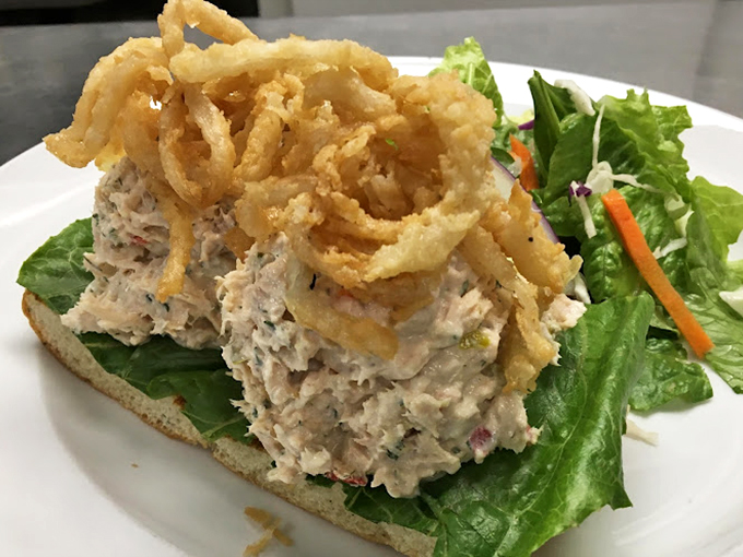 Tuna salad elevated to art form, crowned with crispy onion strings. This isn't your sad desk lunch&mdash;it's the sandwich equivalent of a standing ovation.