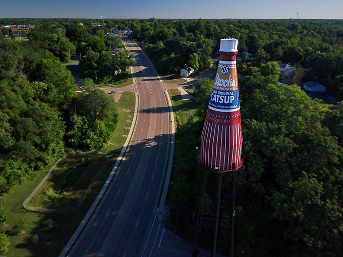 The bottle stands sentinel over the highway, a splash of red and blue against the green Illinois landscape, stopping traffic in more ways than one.