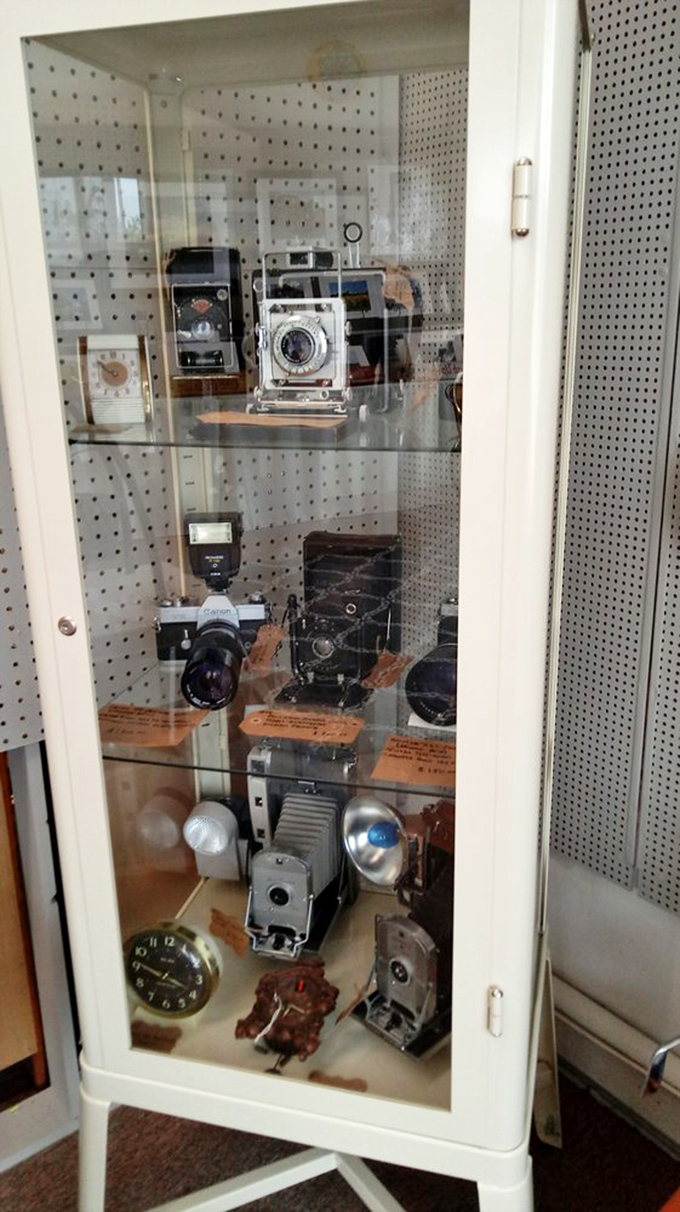 A cabinet of cameras that captured someone's wedding, someone's graduation, someone's first steps&mdash;now waiting for their next chapter.