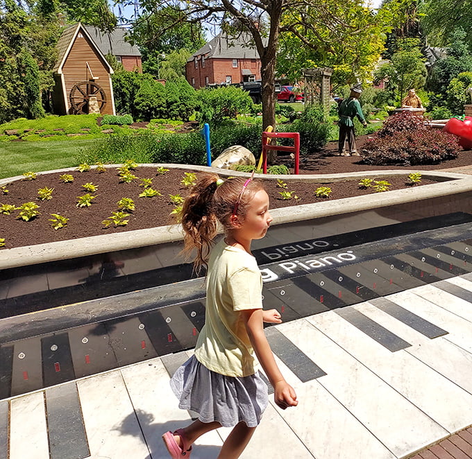 Childhood wonder meets horticultural artistry as young visitors discover the garden's interactive elements, including this playful piano pathway.