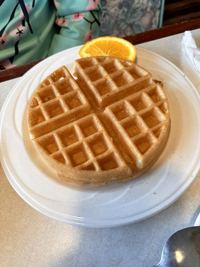 A waffle so perfectly golden it deserves its own Instagram account. That little orange slice is just showing off at this point.
