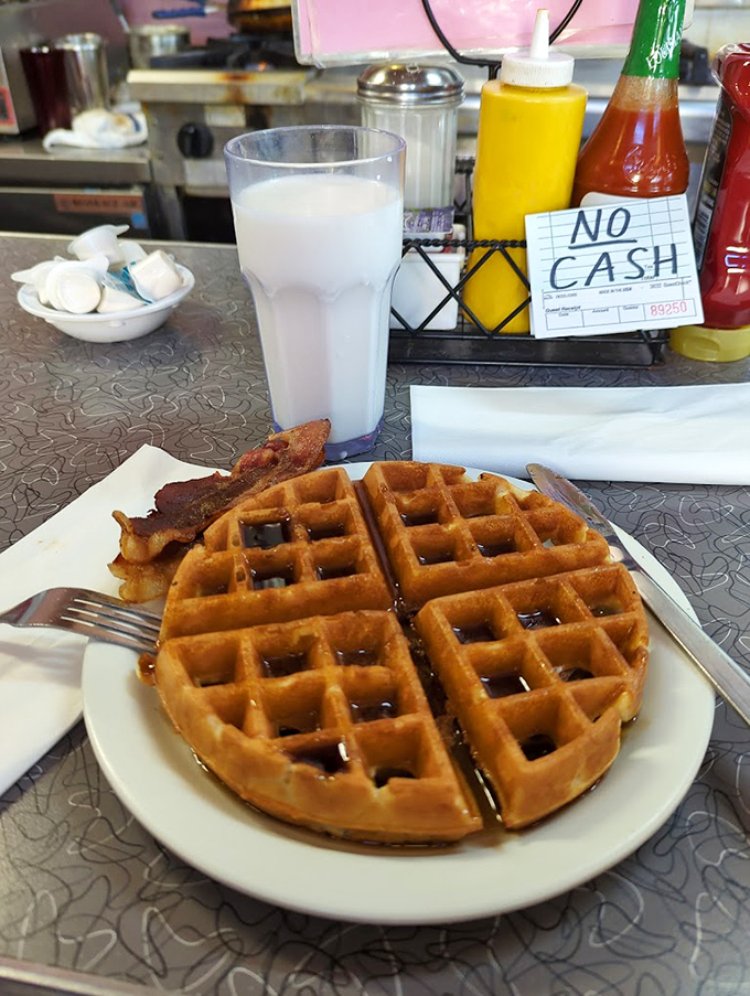 Golden waffle perfection with a side of bacon &ndash; proof that sometimes the simplest pleasures are the ones worth crossing state lines for.