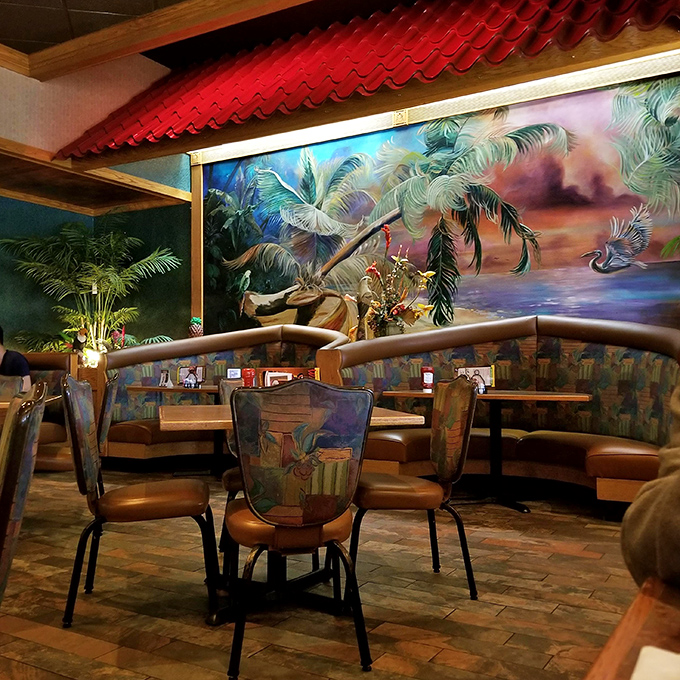 The tropical mural transforms an ordinary meal into dinner theater. Those painted palm trees somehow make the barbecue taste even more authentic.