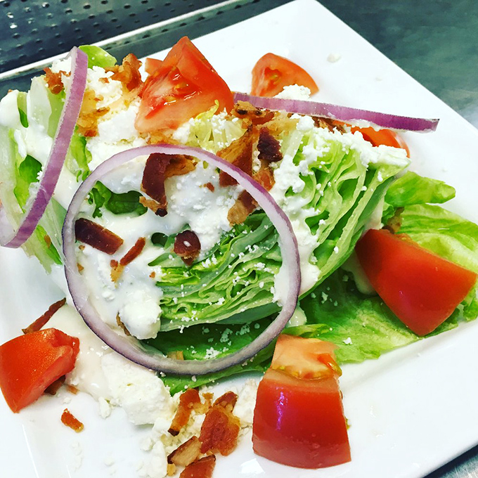 A wedge salad that doesn't mess around &ndash; crisp iceberg, bacon bits, and blue cheese bringing the holy trinity of salad satisfaction.