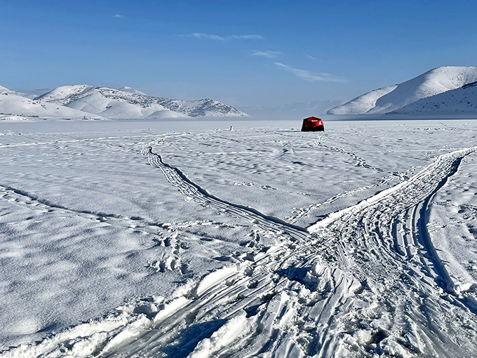 Winter transforms Deer Creek into a snow globe come to life, where ice fishing shelters dot the frozen landscape like colorful confetti.