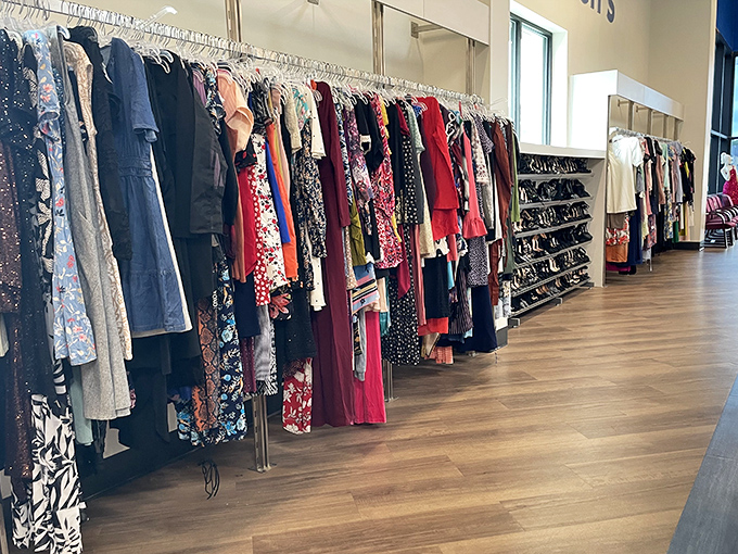 Women's clothing racks stretch toward the horizon like a textile sea, each garment a potential transformation hanging by a thin plastic hanger.